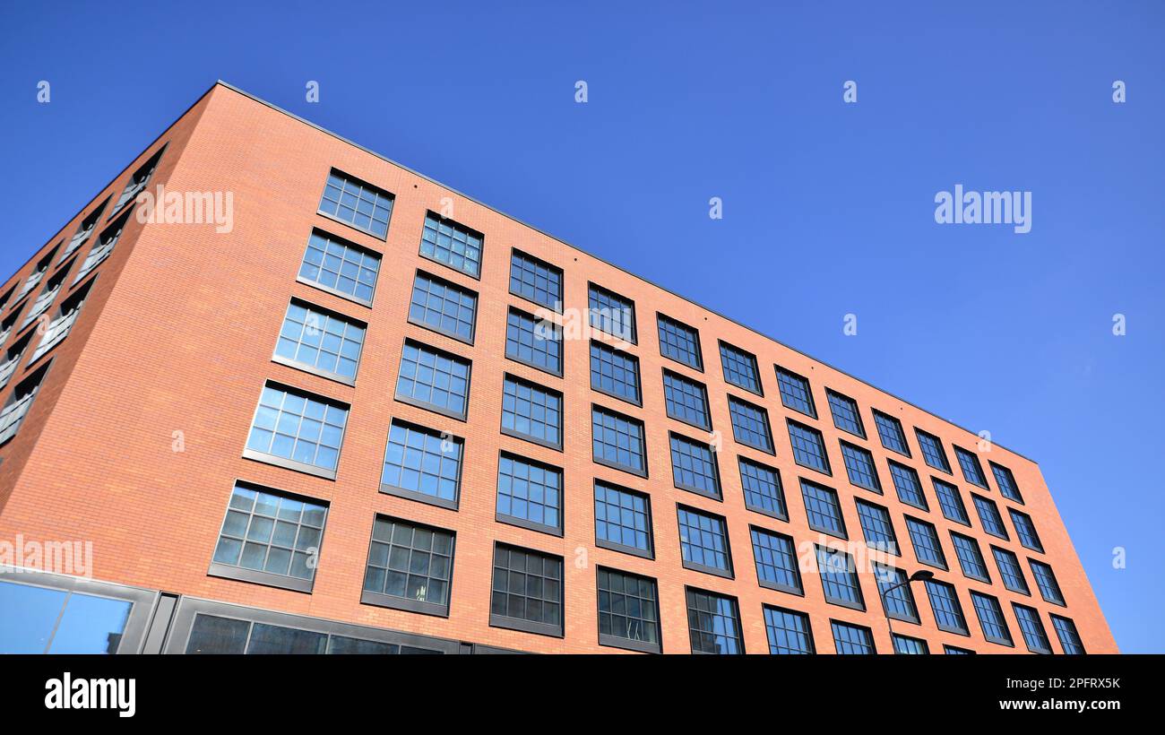 A modern corporate building in the city. The blue sky is reflected in ...
