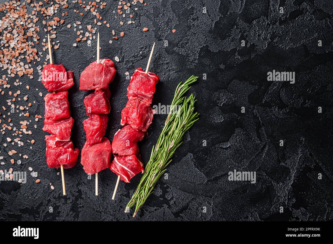Shashlik raw beef veal shish kebab, Meat with herbs on Skewers. Black ...