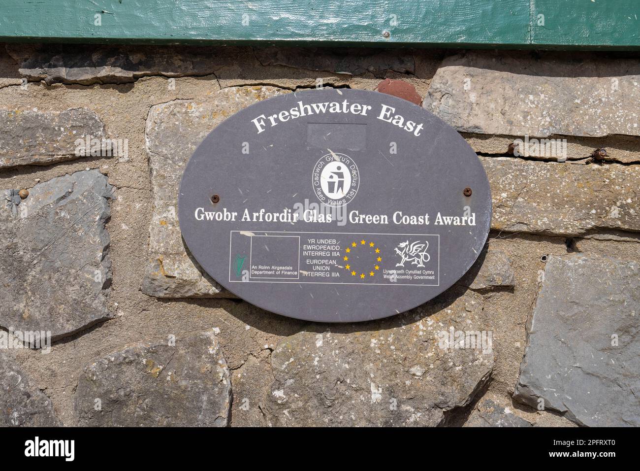 Freshwater East green coastal award plaque screwed to a wall Stock ...
