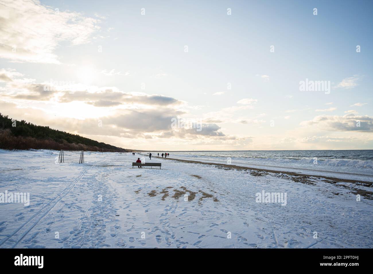Baltic Sea in Winter. People walking on the Beach covered in Snow near ...