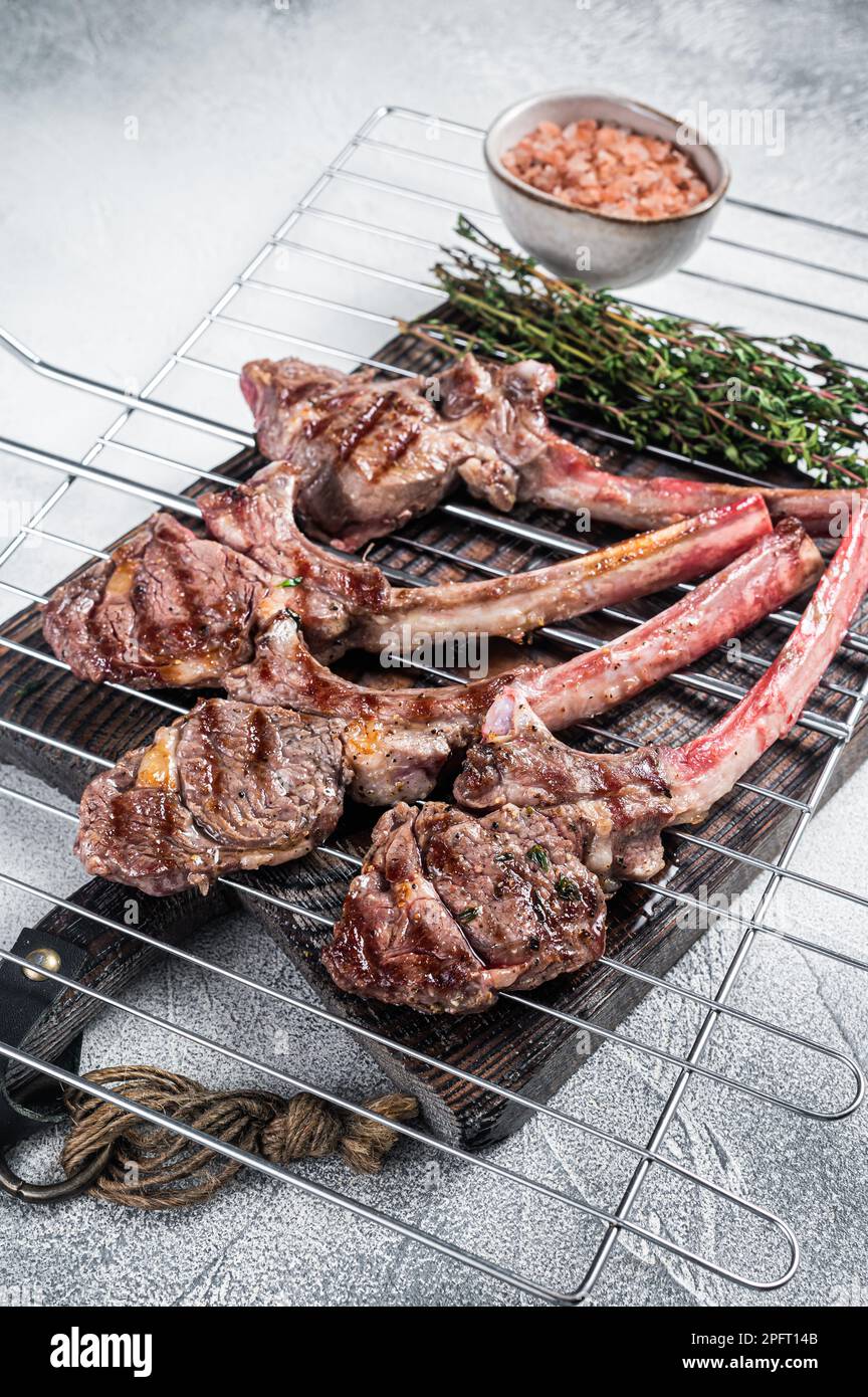 Barbecue grilled lamb meat chop on a grill, mutton rib cutlet. White ...