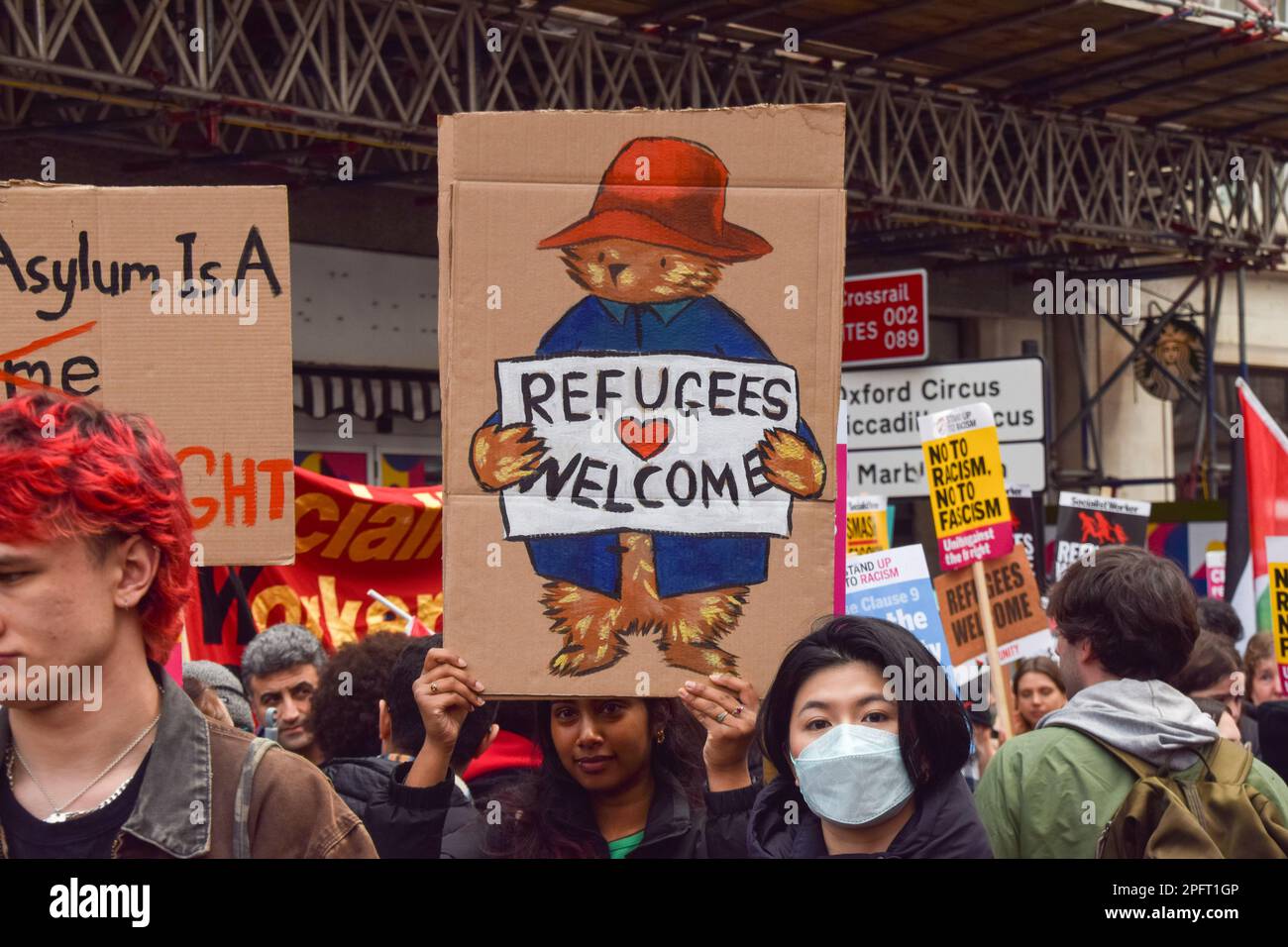 London, England, UK. 18th Mar, 2023. A protester holds a 'Refugees ...