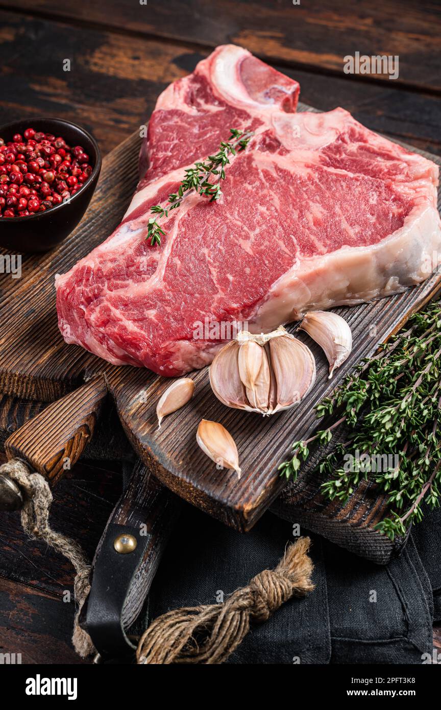 Prime T-bone beef meat steak, raw porterhouse steak on butcher board ...