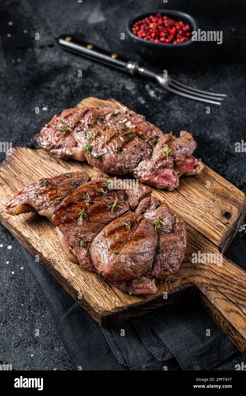 Rost Lamb leg fillet steaks, mutton meat with spices. Black background ...