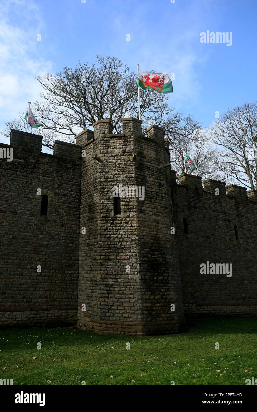 Cardiff Castle, view of a tower and red dragon flag from outside castle ...