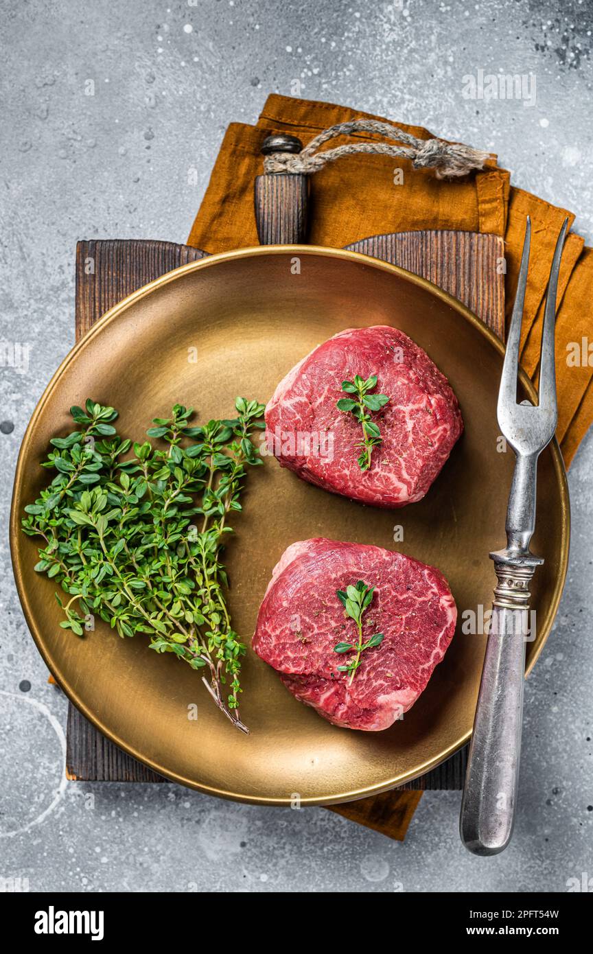 Dry aged Fillet Mignon Beef steak with herbs, raw marble meat. Gray ...