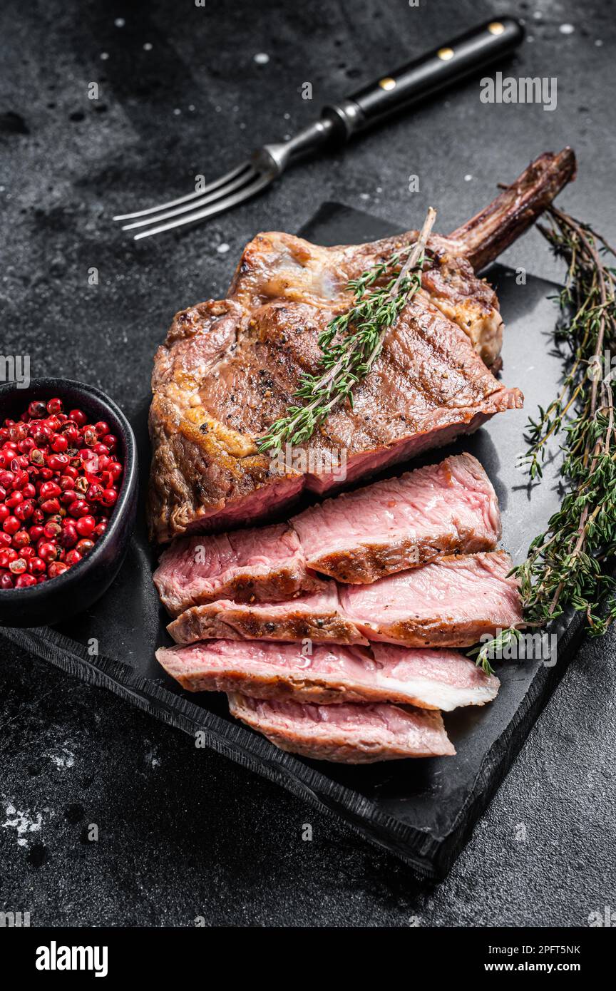 Grilled Tomahawk Beef Steak, Rib eye with thyme. Black background. Top ...