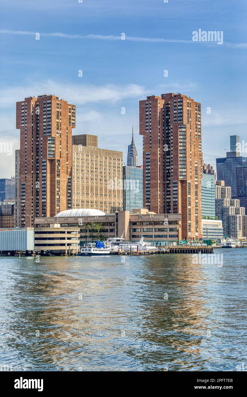 Chrysler Building’s iconic spire framed by the brick towers of ...
