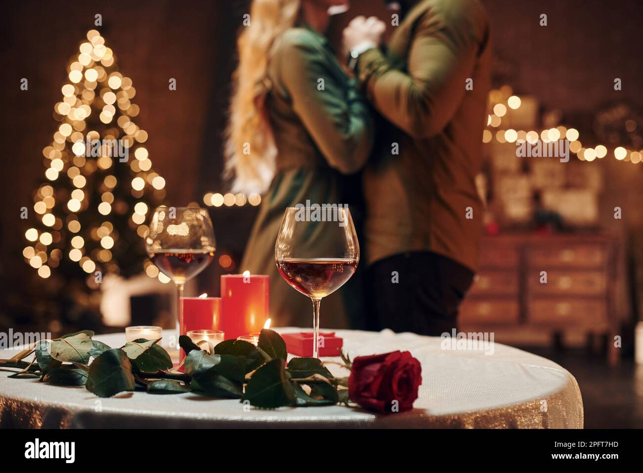 Standing and dancing. Young lovely couple have romantic dinner indoors ...