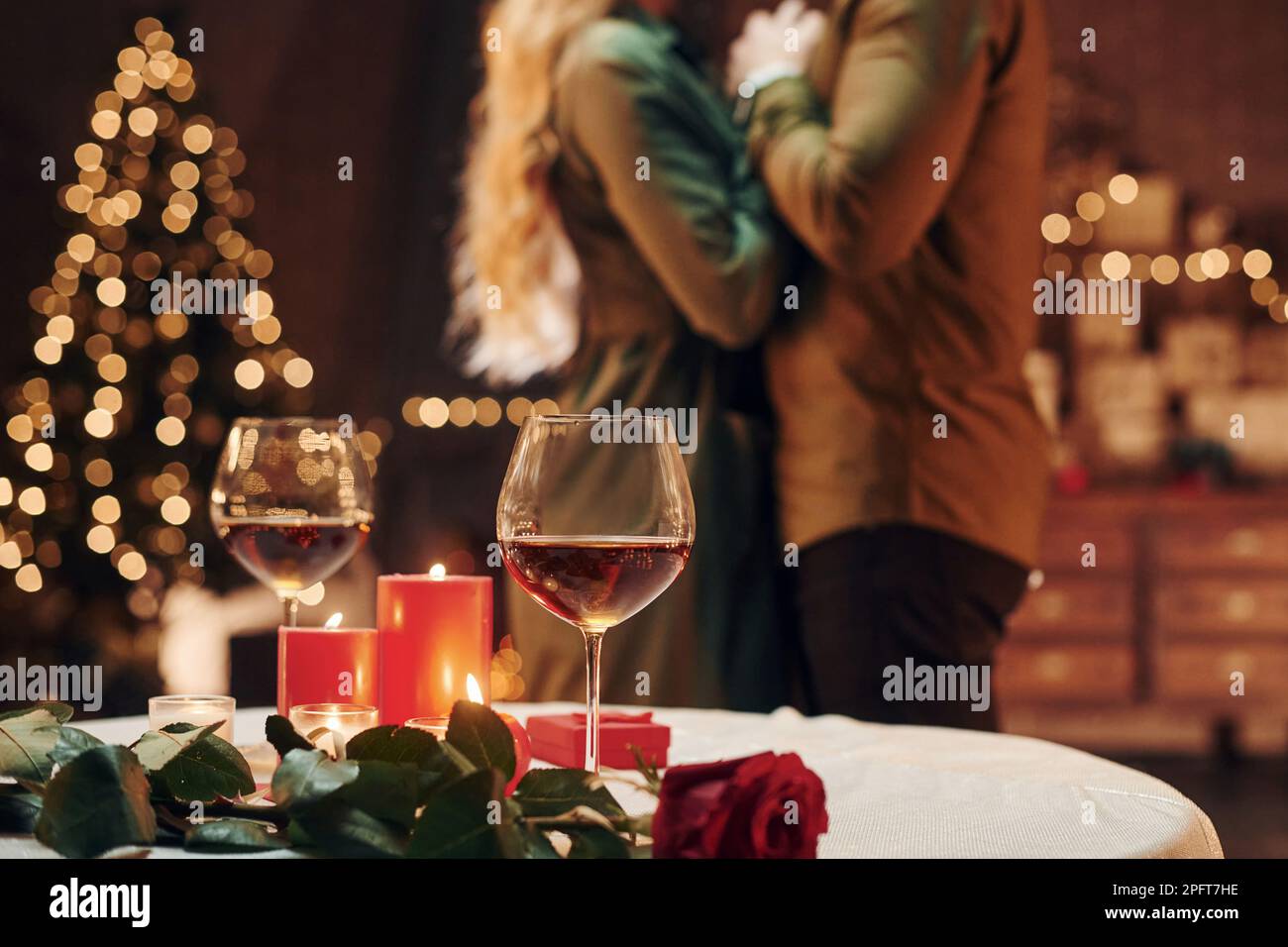 Standing and dancing. Young lovely couple have romantic dinner indoors ...