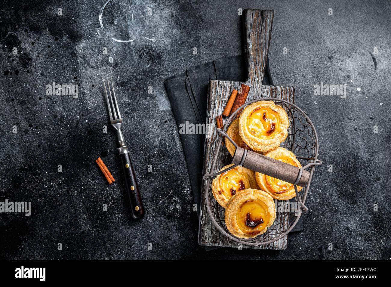 Traditional Lisbon Pasteis de nata in a basket. Black background. Top ...
