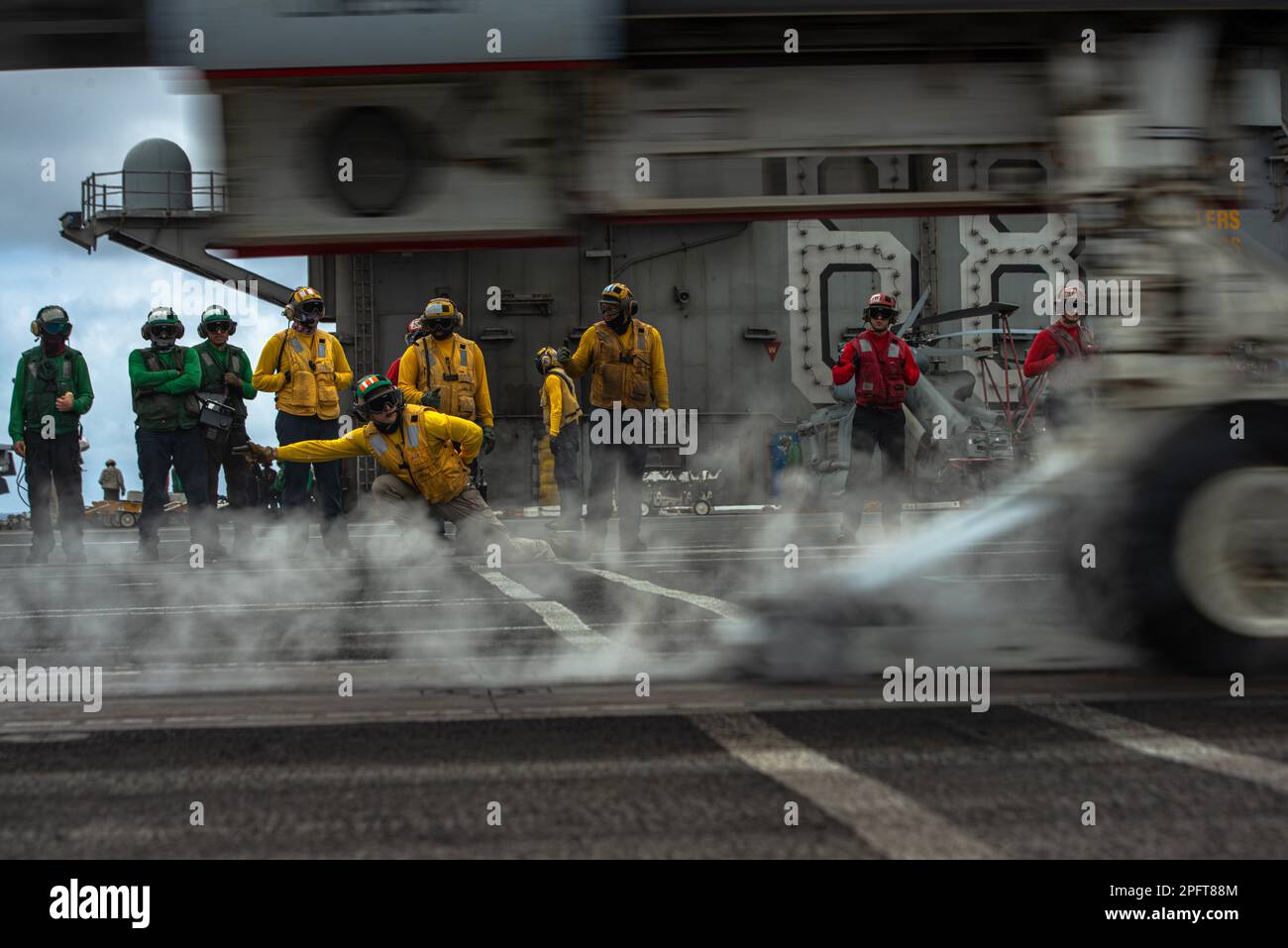 230318-N-MH015-1094 PHILIPPINE SEA (March 18, 2023) A U.S. Navy Sailor launches an aircraft from ...