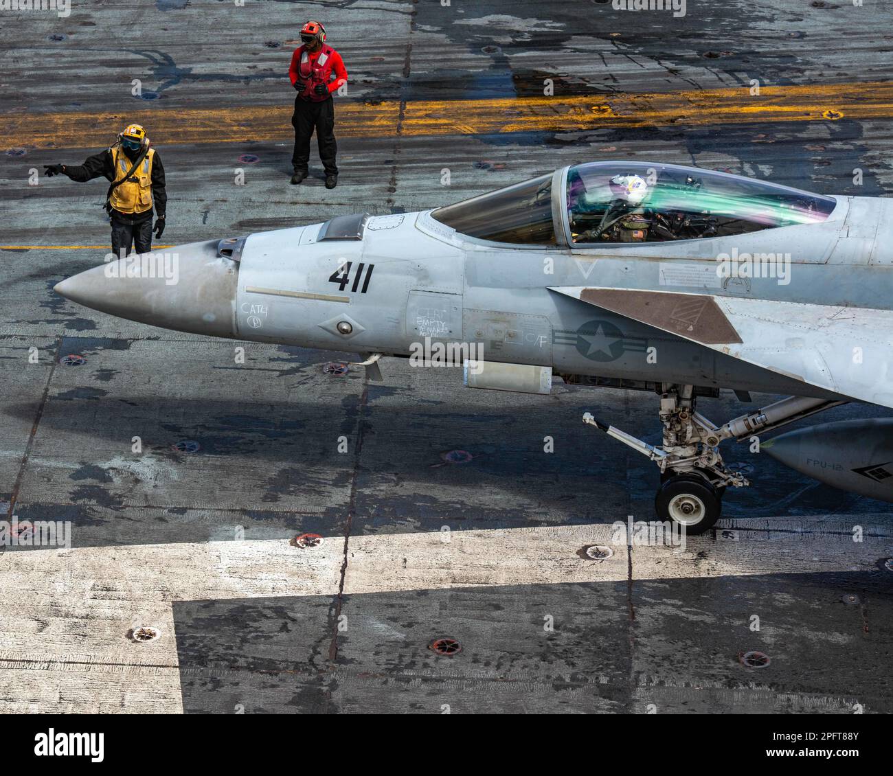 230318-N-NX635-1059 PHILIPPINE SEA (March 18, 2023) A U.S. Navy Sailor directs an F/A-18F Super ...