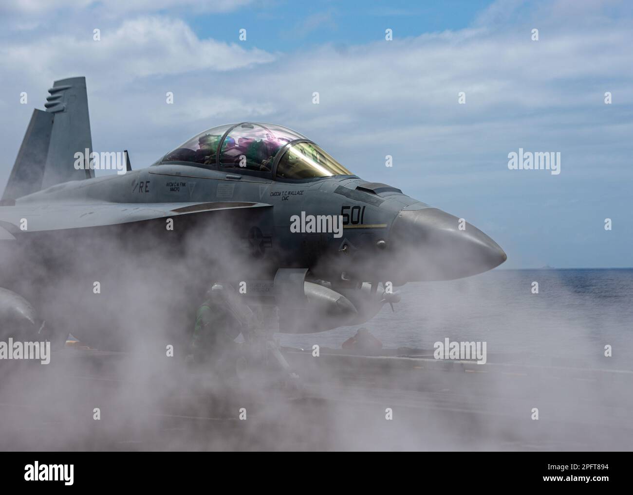 230318-N-MH015-1022 PHILIPPINE SEA (March 18, 2023) A U.S. Navy Sailor directs an E/A-18G ...