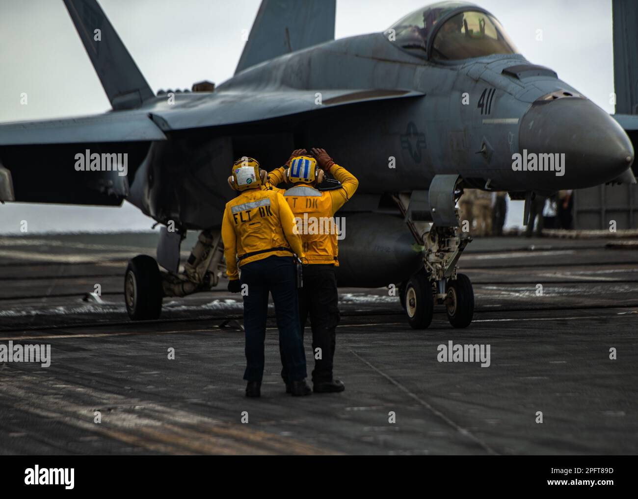 230318-N-MH015-1011 PHILIPPINE SEA (March 18, 2023) A U.S. Navy Sailor directs an F/A-18E Super ...