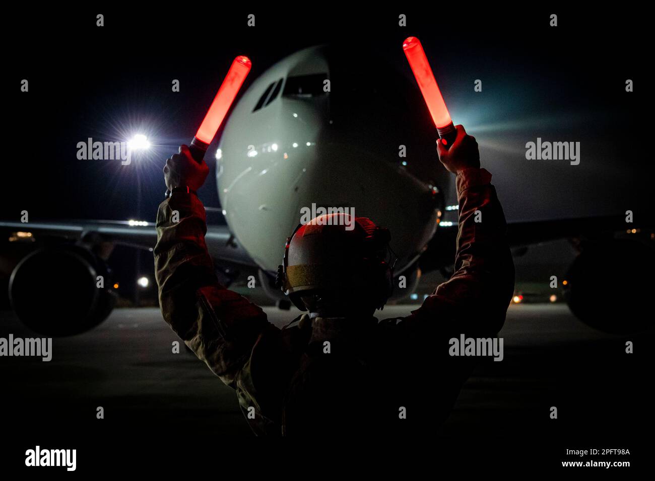 A 621st Contingency Response Wing Airman marshals a Delta aircraft for ...