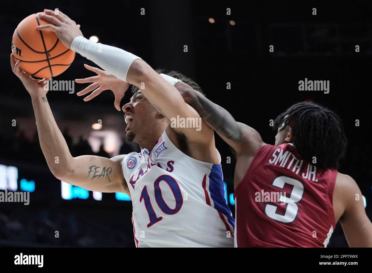 Arkansas' Nick Smith Jr. fouls Kansas' Jalen Wilson during the first ...