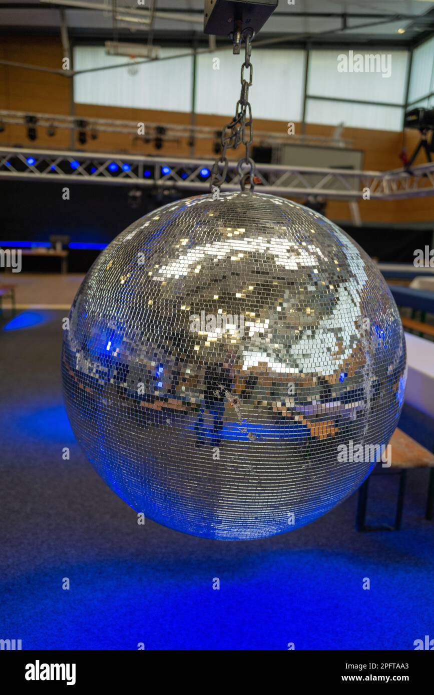 a huge disco ball hangs on a scaffold Stock Photo - Alamy