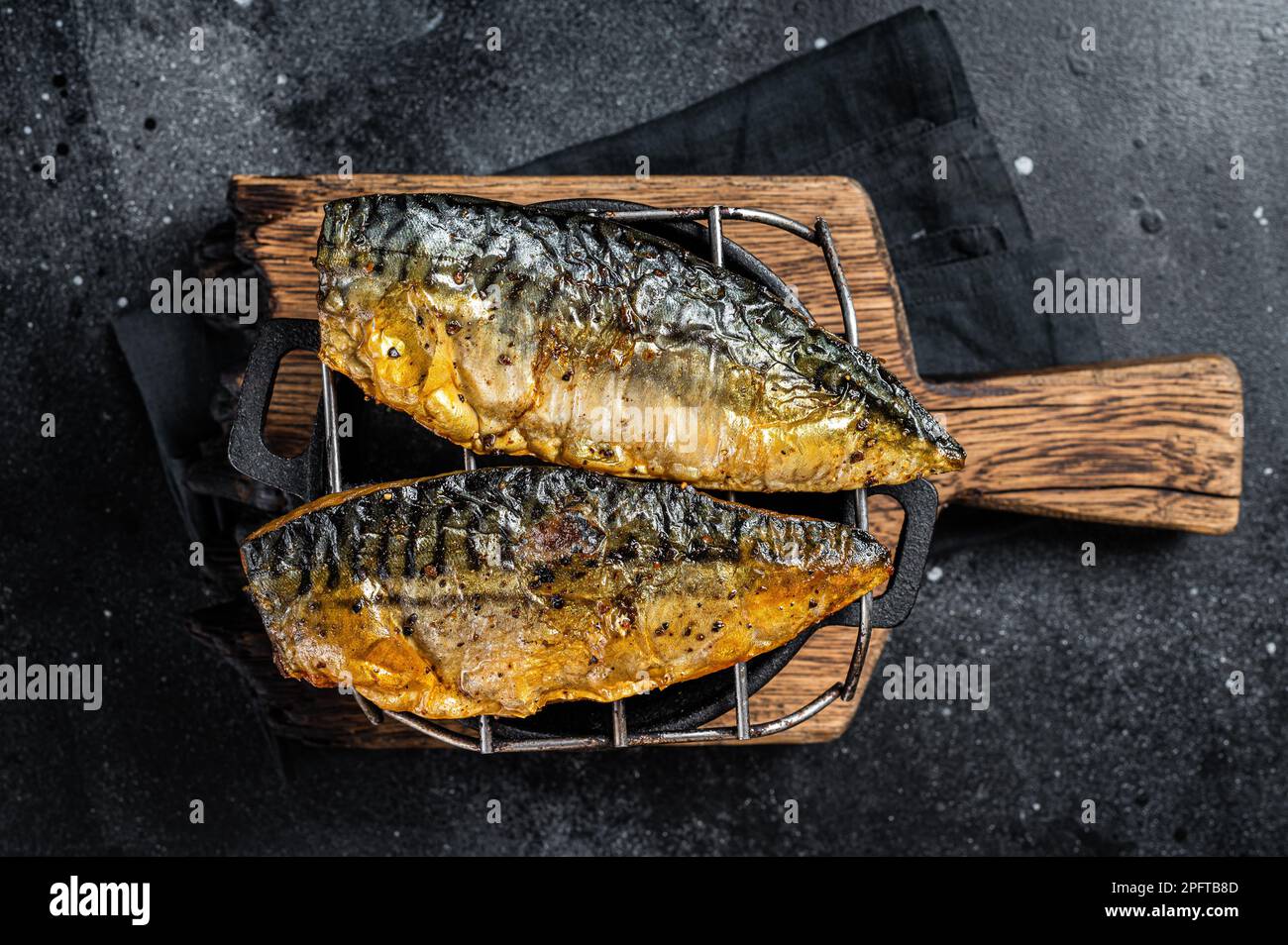 Grilled mackerel fish fillet on a grill. Black background. Top view ...