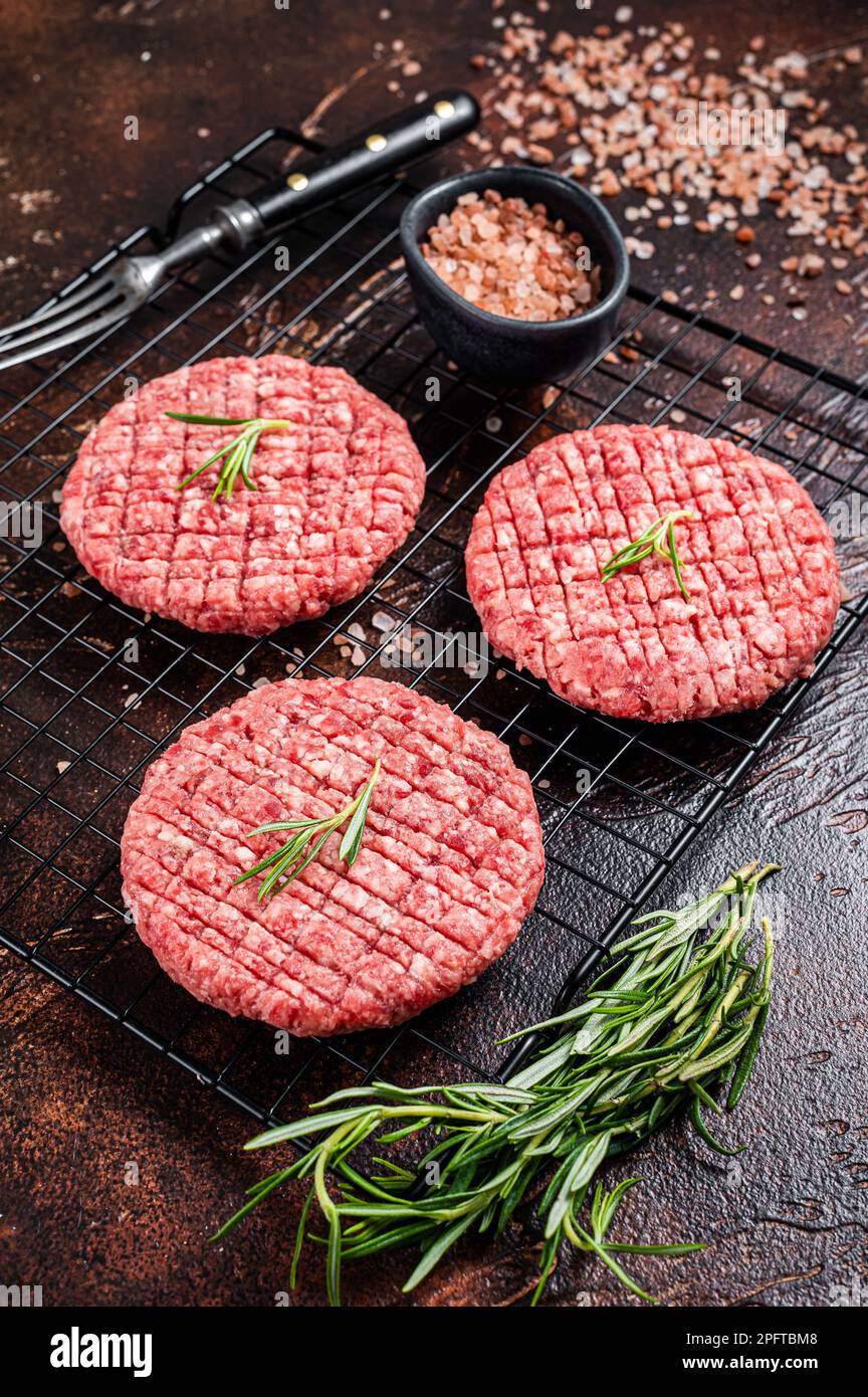 Raw burger cutlet from beef meat with spices and rosemary ready for ...