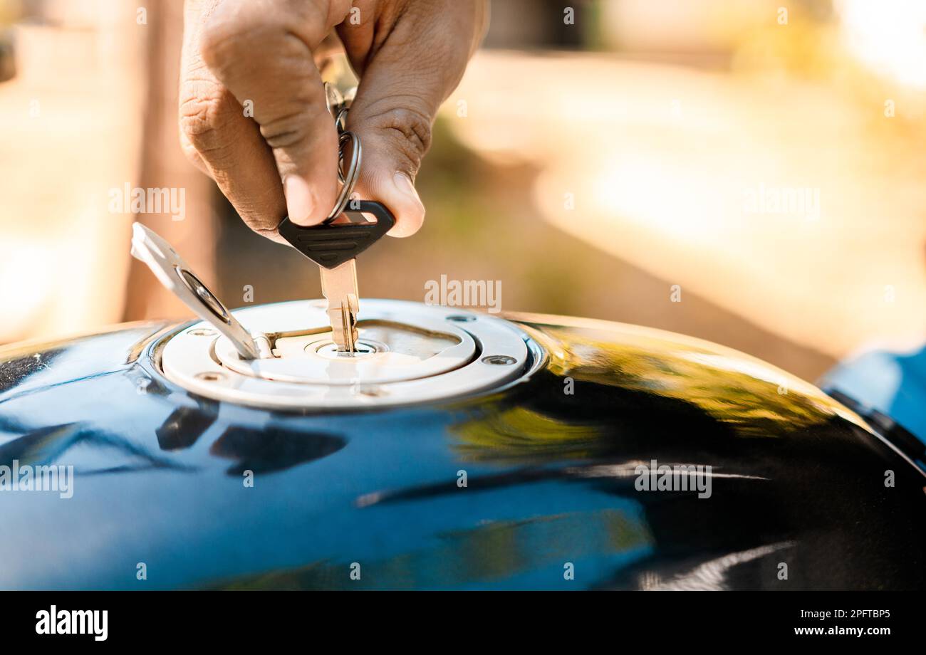 Hand opening the gas tank of the motorcycle, Motorcyclist opening the ...