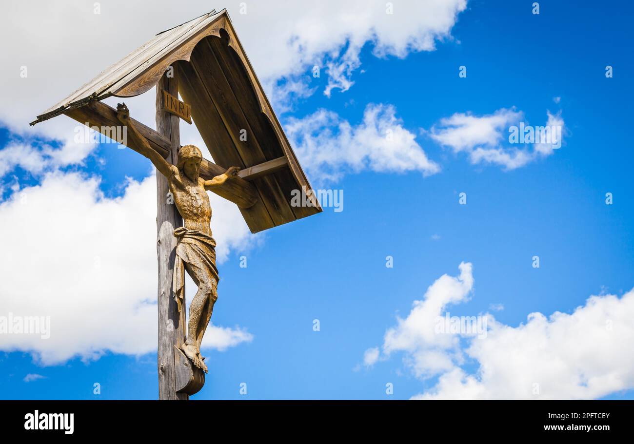 A 100 years old Crucifix, made of wood, tipical of Dolomity Region in ...