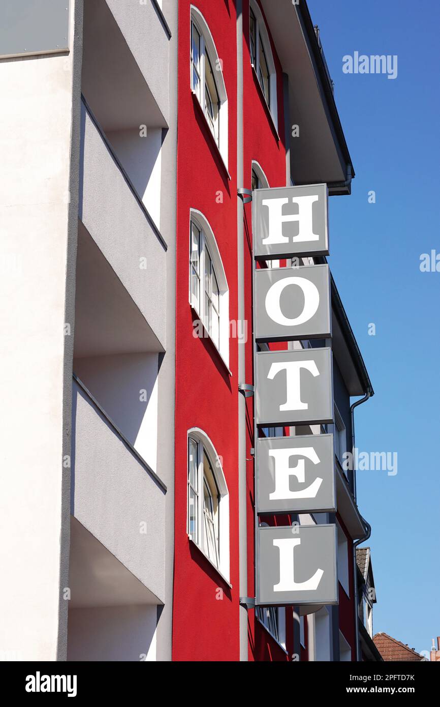 hotel sign on building exterior. vertical signage Stock Photo - Alamy
