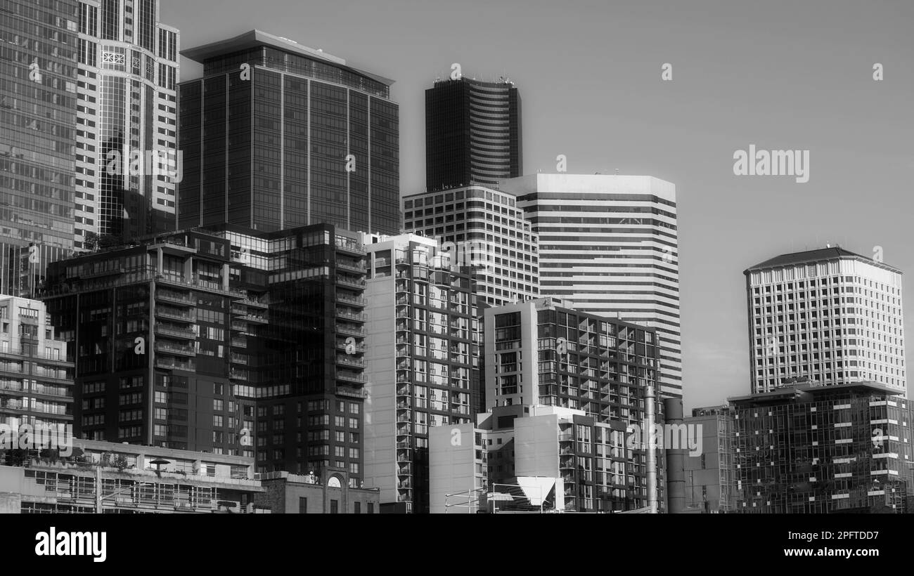 A black and white photograph of a city skyline with tall buildings ...