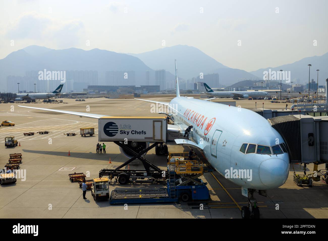 Hong Kong - March 1, 2023: Airplane at boarding gate jet bridge in Hong ... Hong Kong - March 1, 2023: Airplane at boarding gate jet bridge in Hong ...