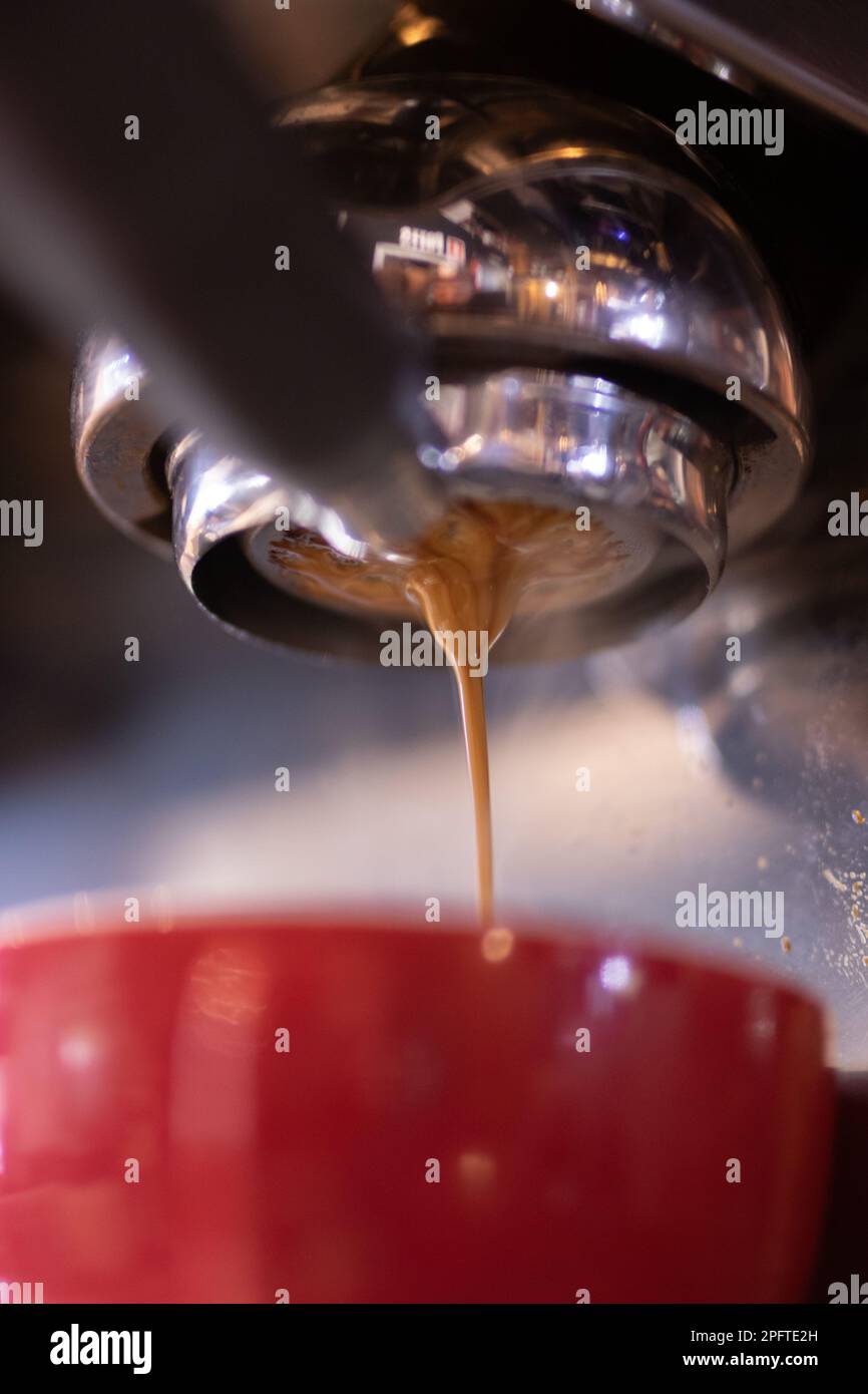 Coffee falling from the filter to the red cup. Seen from below Stock ...