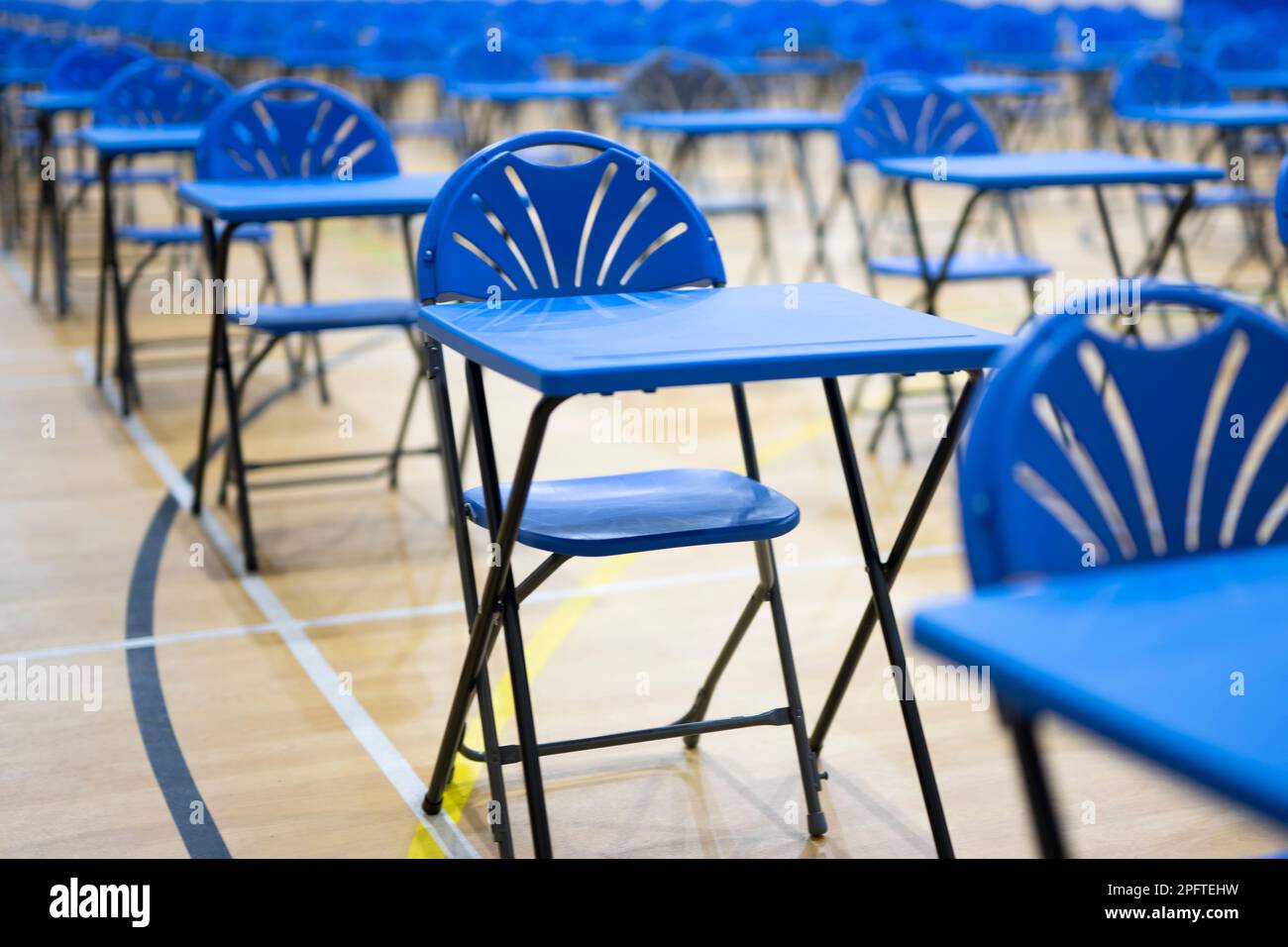 Exam desks laid out in a school hall Stock Photo - Alamy
