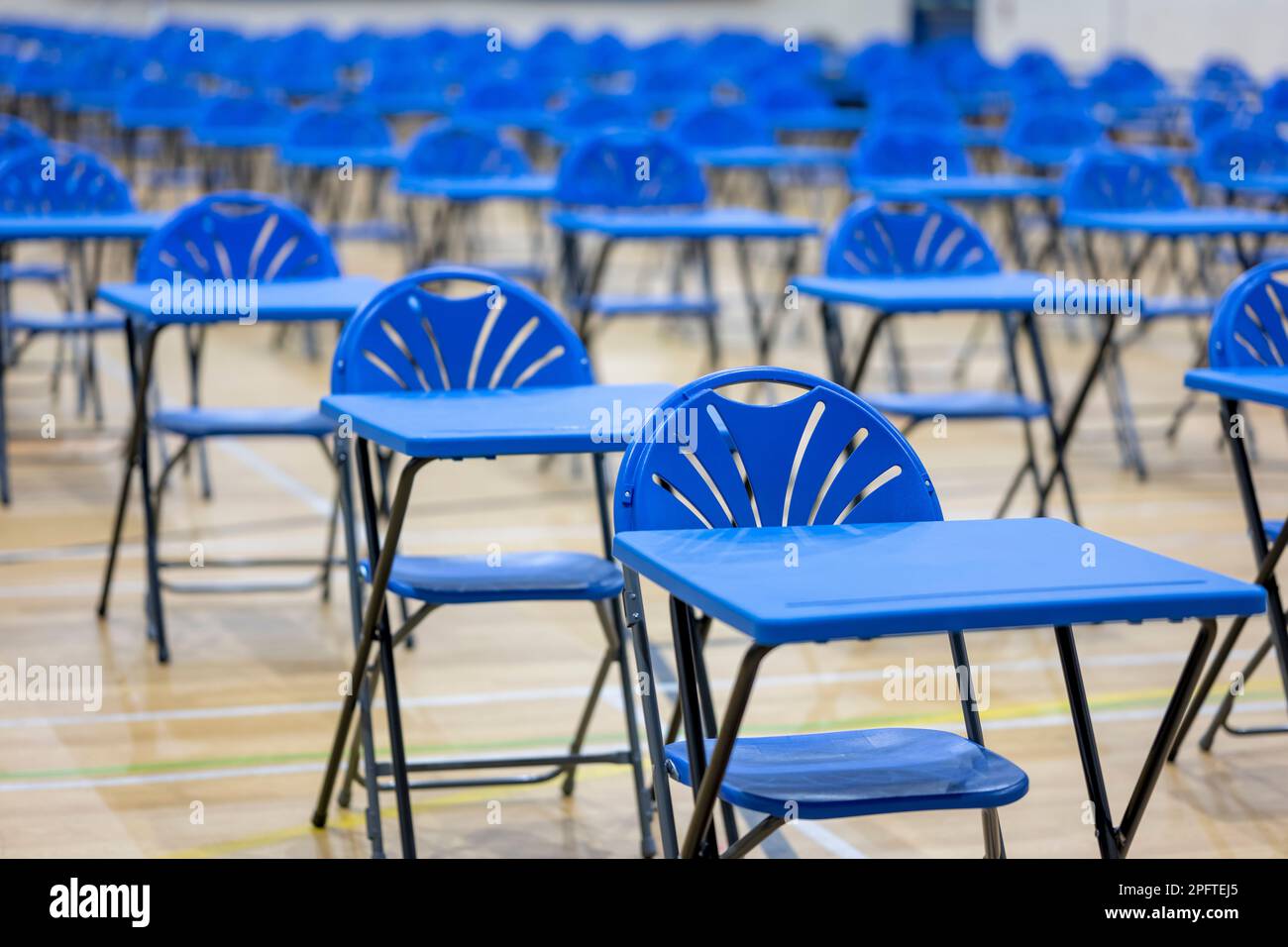 Exam desks laid out in a school hall Stock Photo - Alamy