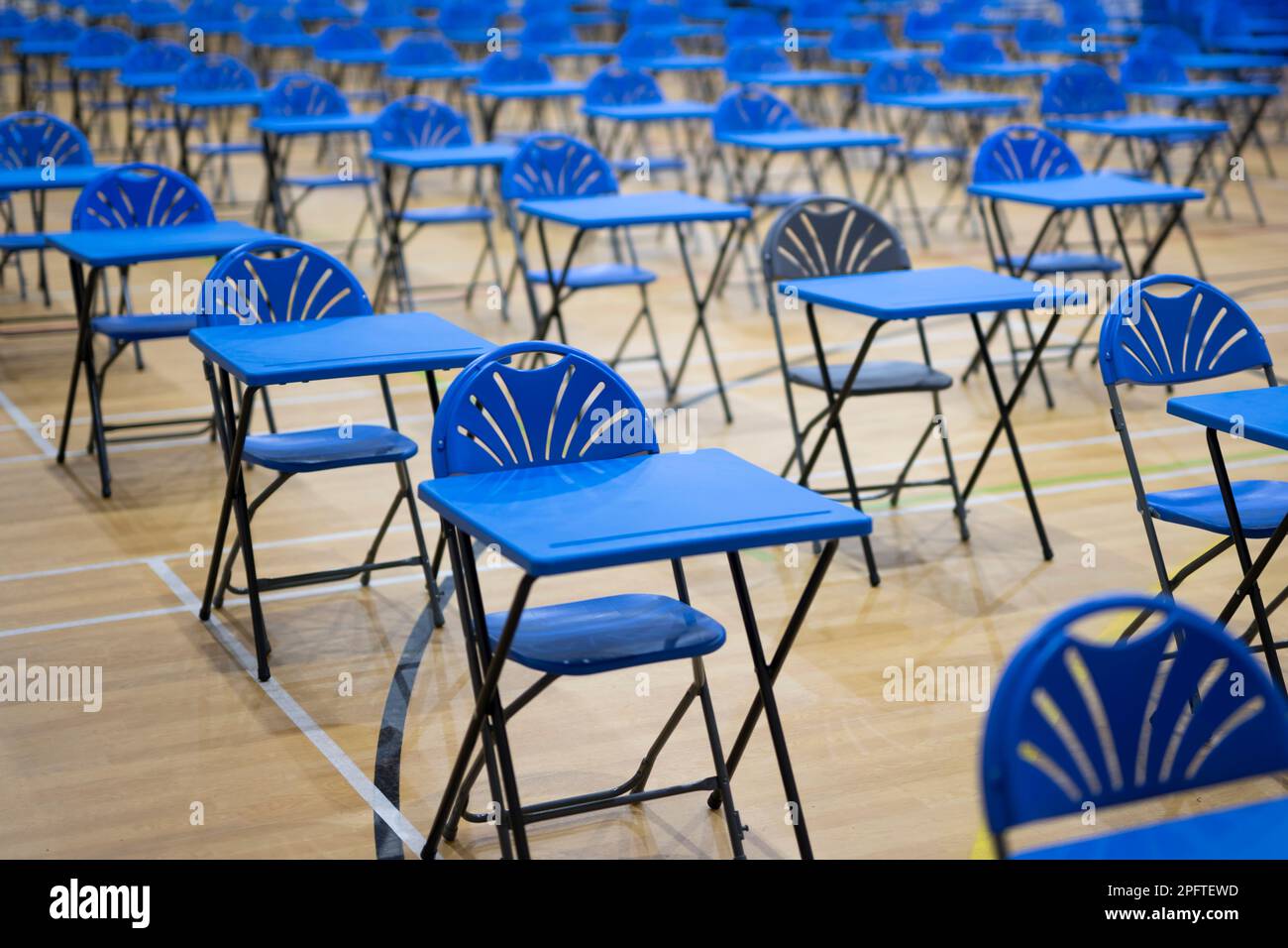 Exam desks laid out in a school hall Stock Photo - Alamy