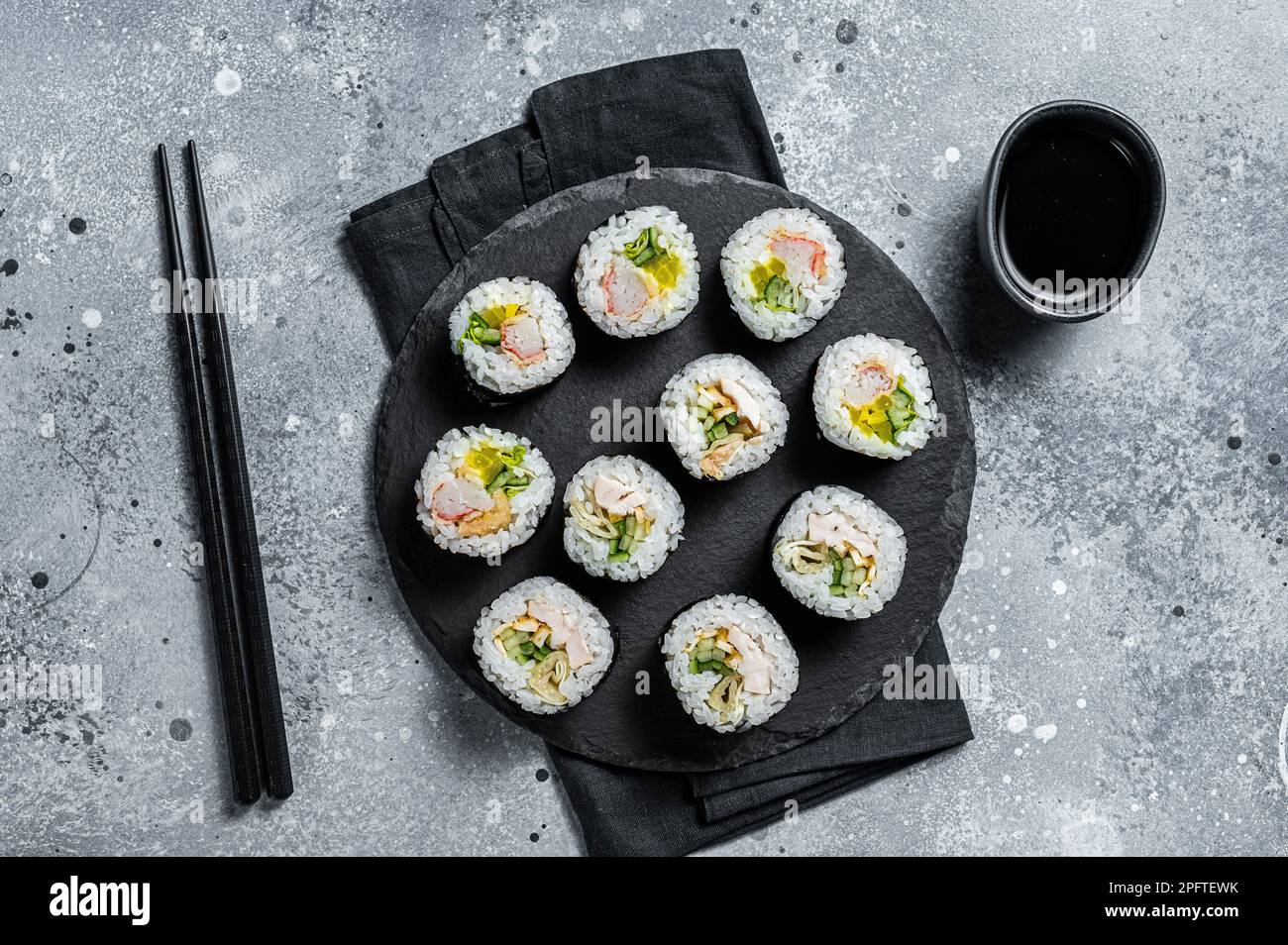 Korean style sushi Kimbap or gimbap made from steamed white rice. Gray ...