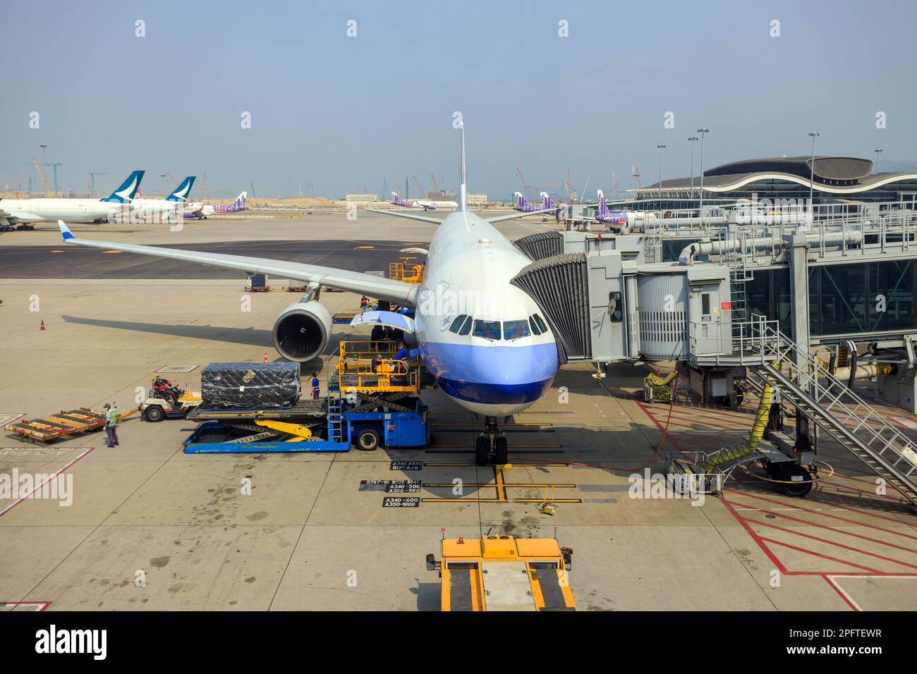 Hong Kong - March 1, 2023: Airplane at boarding gate jet bridge in Hong ...