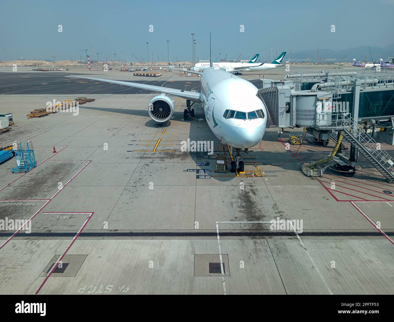 Hong Kong - March 1, 2023: Airplane at boarding gate jet bridge in Hong ...