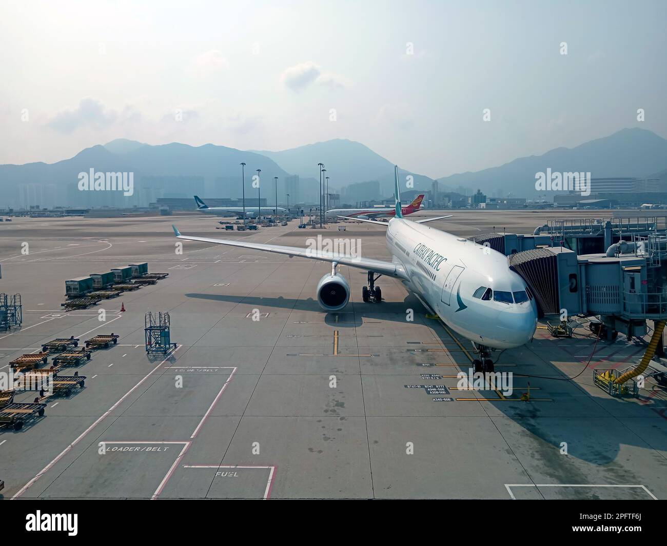 Hong Kong - March 1, 2023: Airplane at boarding gate jet bridge in Hong ...