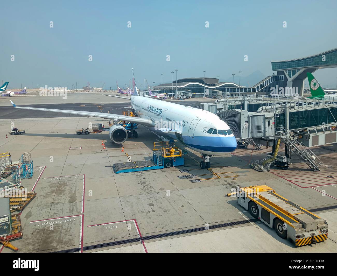 Hong Kong - March 1, 2023: Airplane at boarding gate jet bridge in Hong ...