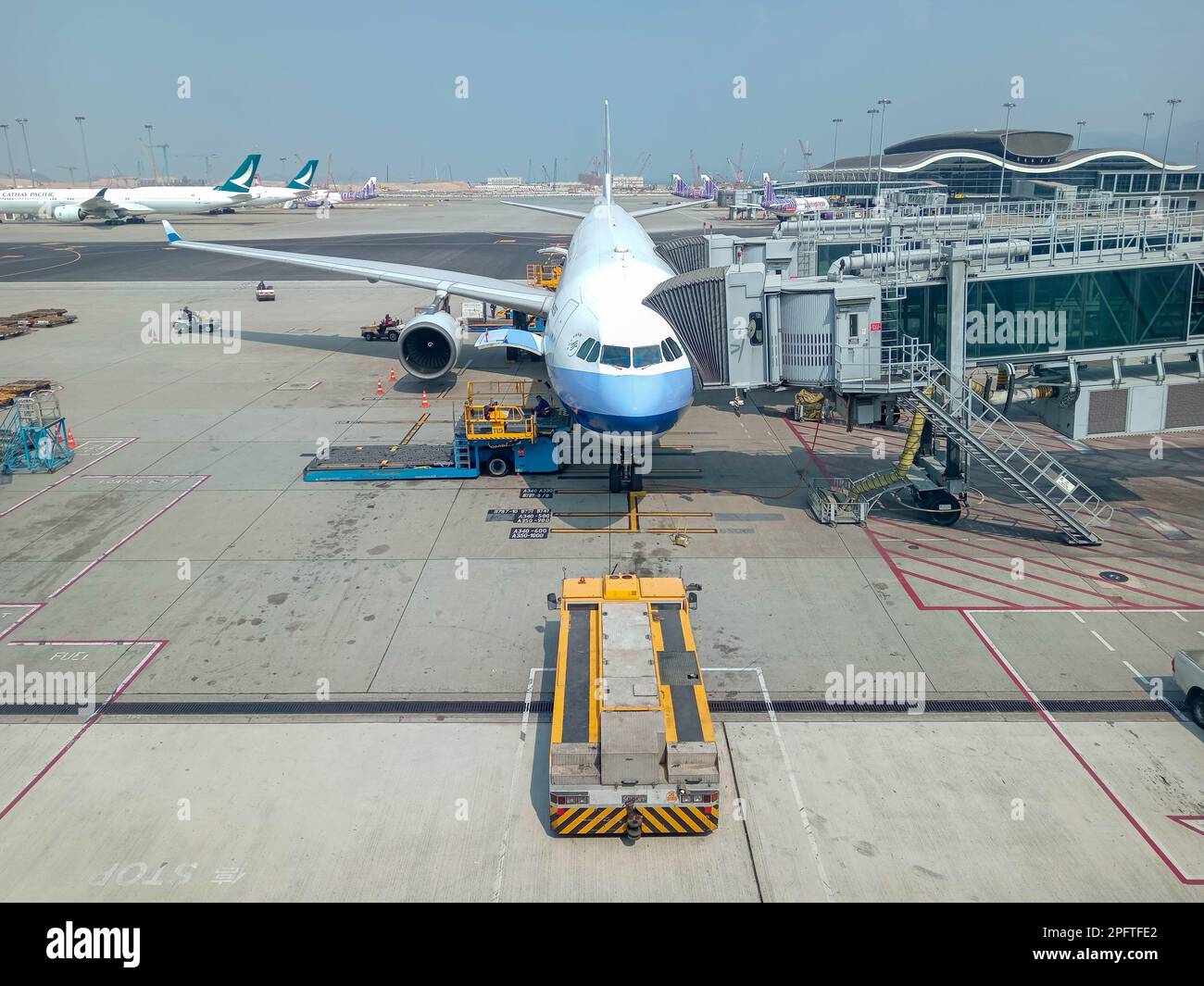 Hong Kong - March 1, 2023: Airplane at boarding gate jet bridge in Hong ...