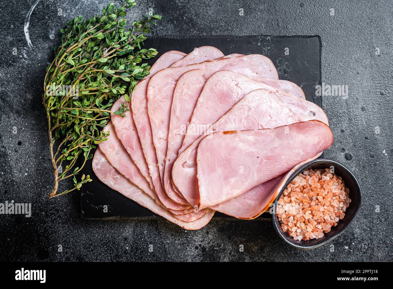 Squared slices of lean pork ham. Black background. Top view Stock Photo ...