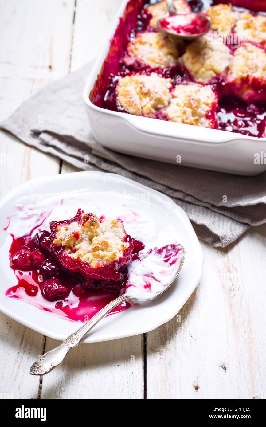 Homemade cherry cobbler pie with flaky crust, ice cream, vintage spoon ...