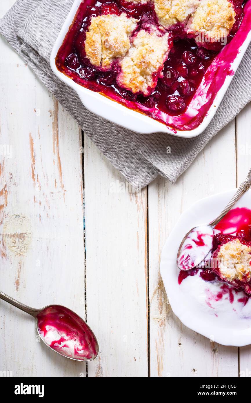 Homemade cherry cobbler pie with flaky crust, ice cream, vintage spoon ...