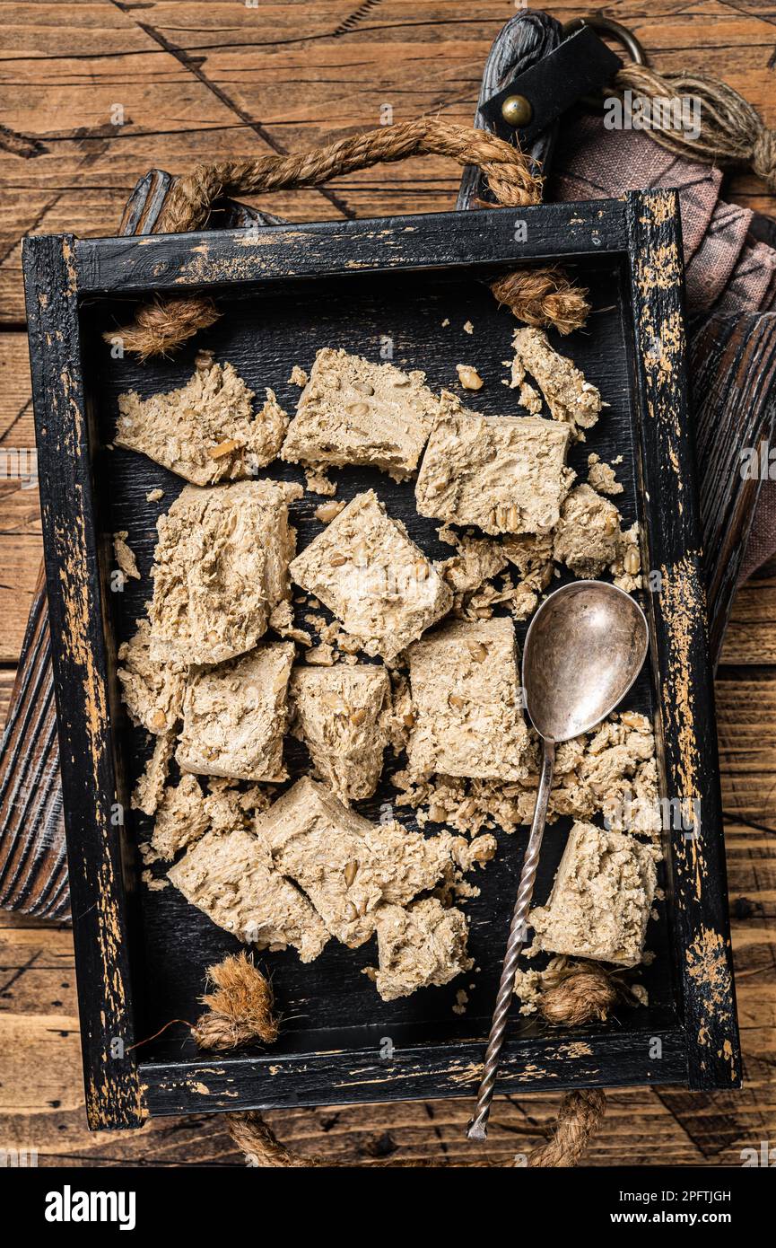 Turkish Halva with sunflower seeds and honey in wooden tray. Wooden background. Top view Stock ...