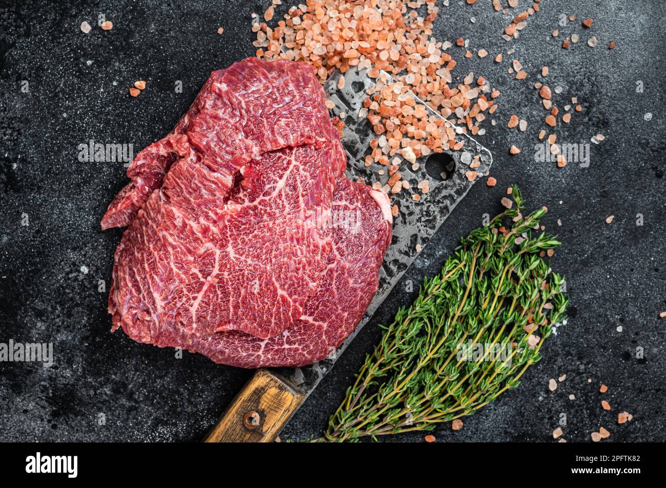 Raw Beef cheeks, fresh veal meat on butcher cleaver. Black background ...