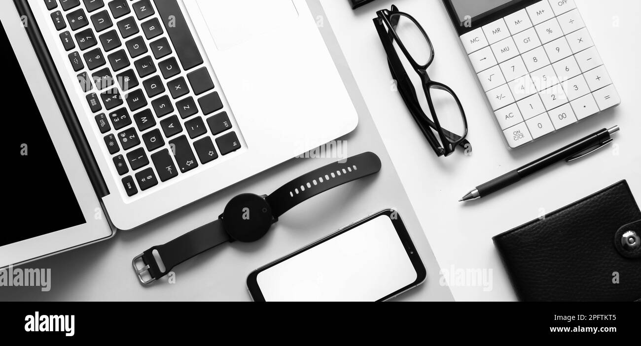 Different modern devices with eyeglasses, calculator and wallet on ...