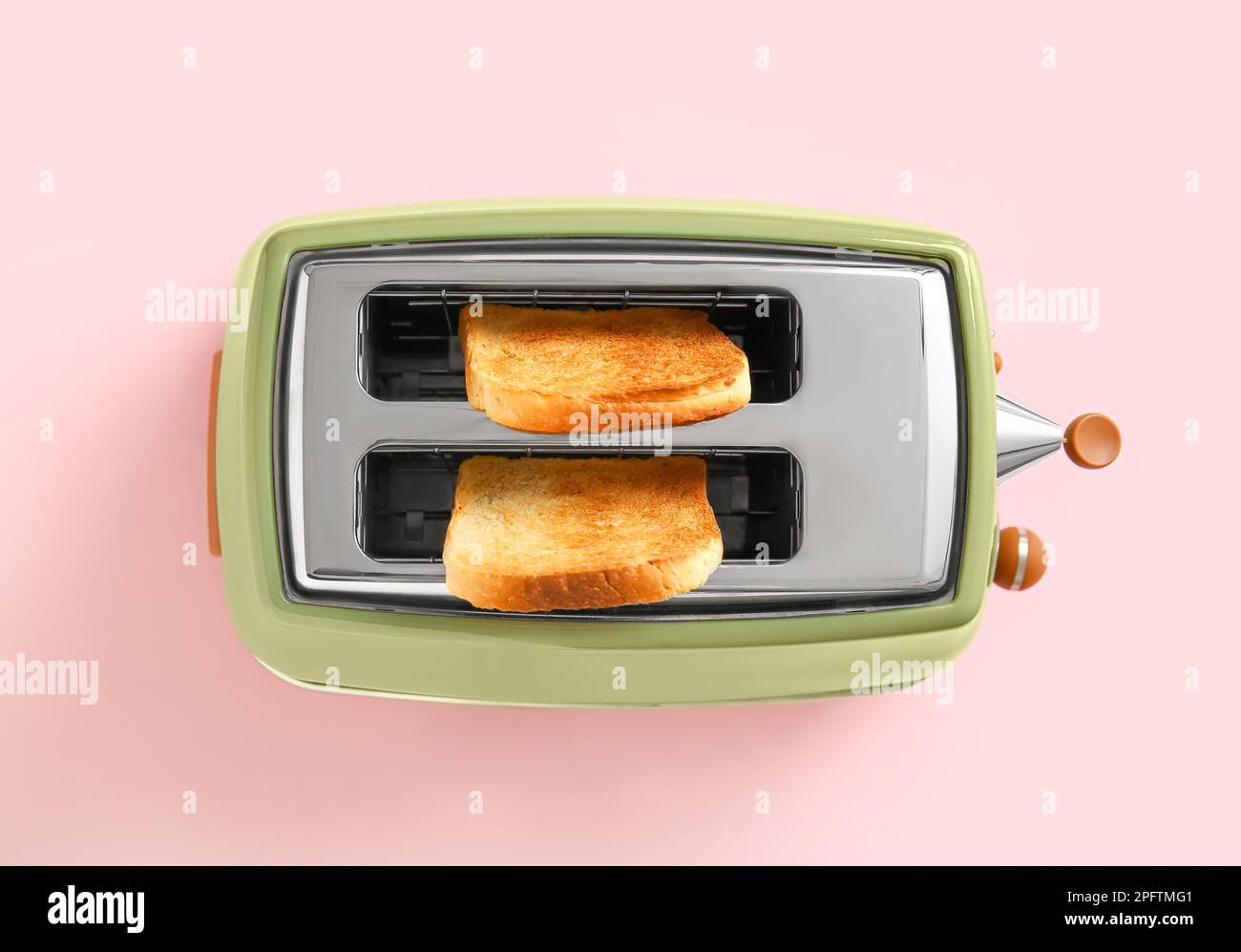 Modern toaster with crispy bread slices on pink background Stock Photo - Alamy