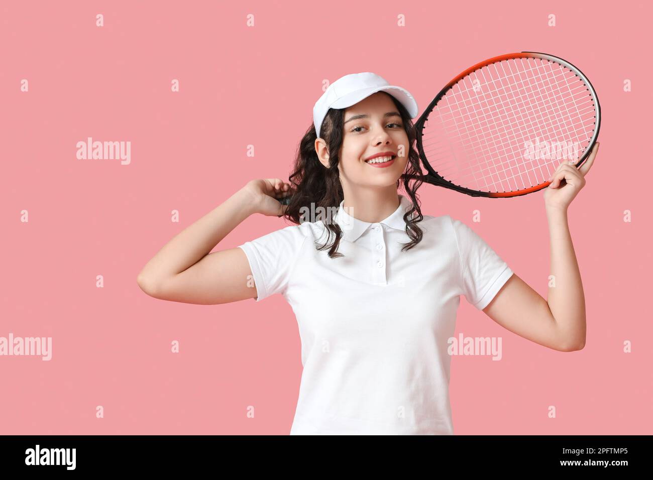 Teenage tennis player with racket on pink background Stock Photo - Alamy