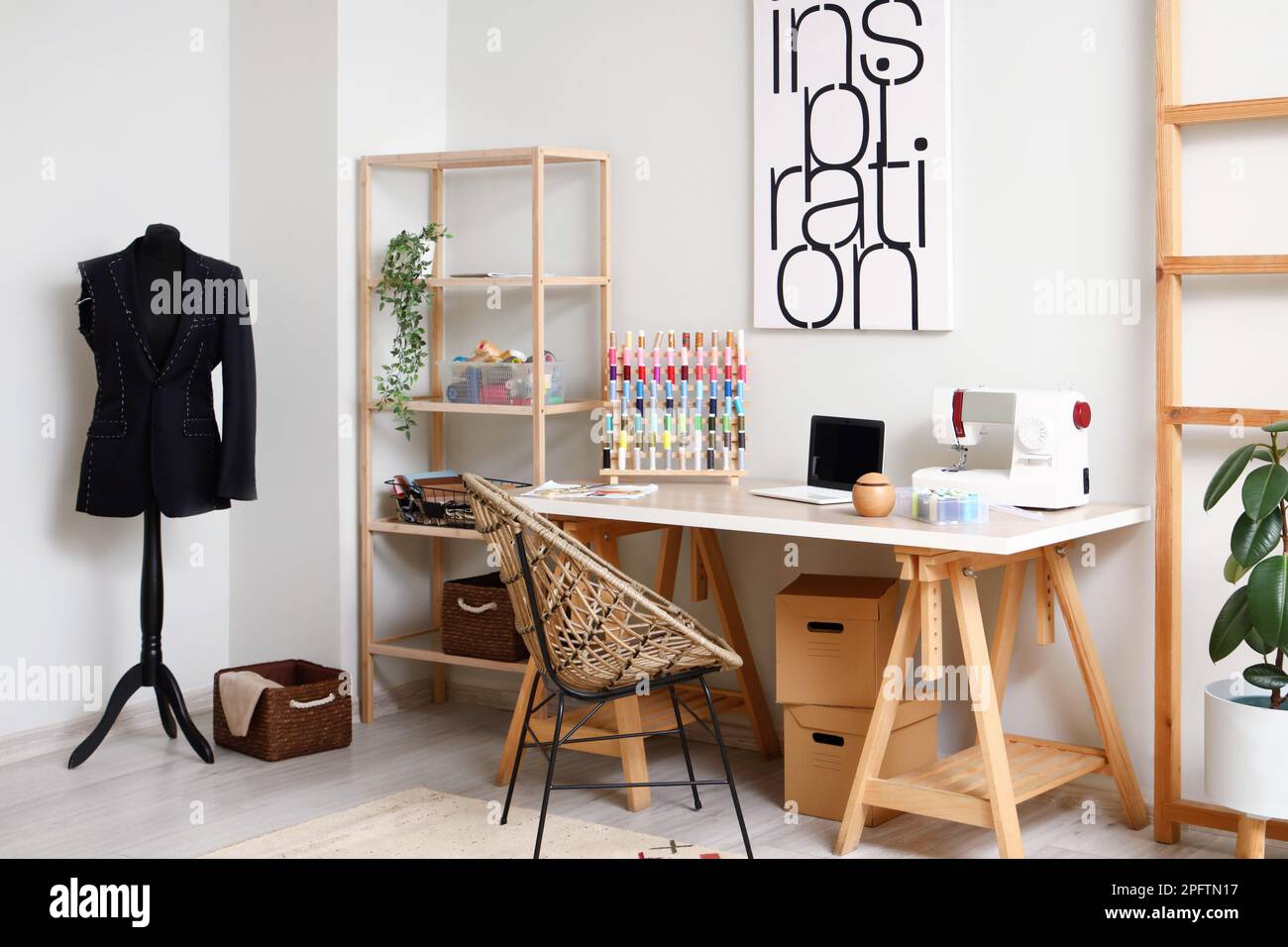 Interior of modern atelier with tailor's workplace, shelving unit and ...