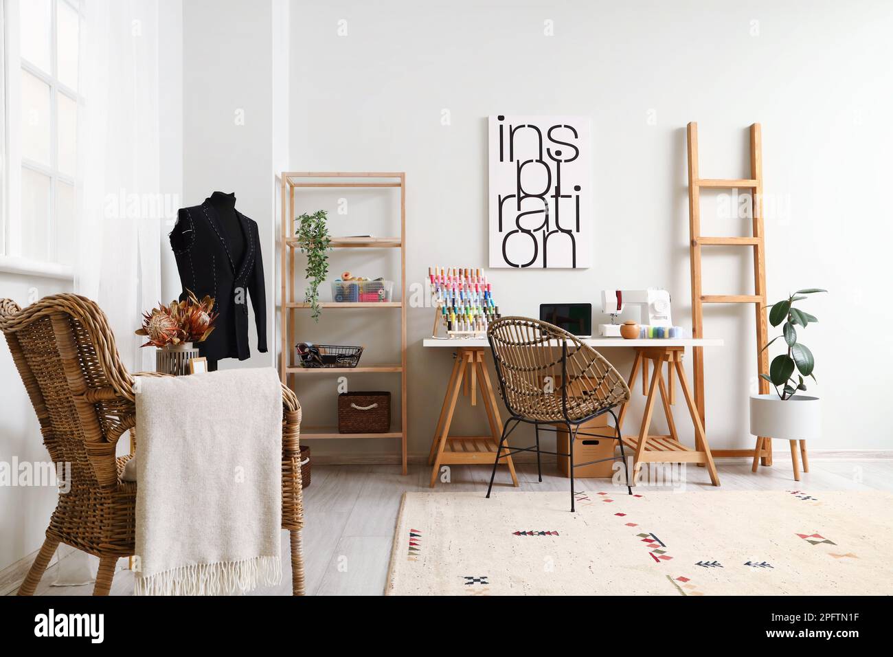 Interior of modern atelier with tailor's workplace, shelving unit and ...