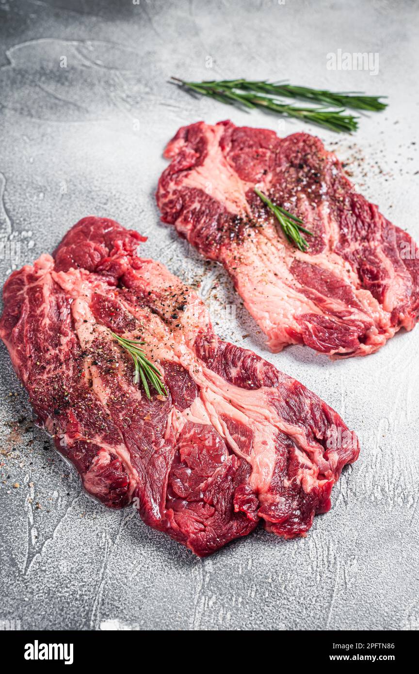 Marbled raw meat Steaks cooking with seasonings and olive oil, fresh ...